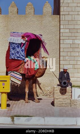 A camel with a howdah carriage outside the Great Mosque at Kairouan ...