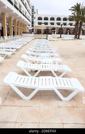 Line of a plastic sunbeds in a luxury hotel Stock Photo - Alamy