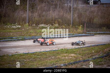 Three RC buggies racing on an outdoor offroad track Stock Photo - Alamy