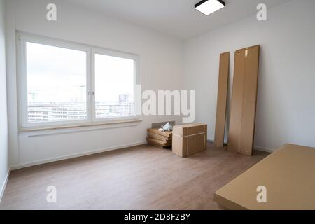 Empty Room With Moving Boxes Or Cartons Stock Photo - Alamy