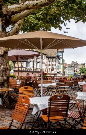 A table at an outdoor restaurant with traditional old terracotta houses ...