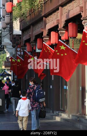 A line of Chinese national flags fly on the street prior to the ...