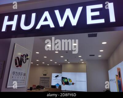 Consumers choose phones at a Huawei service center in Xuchang city ...
