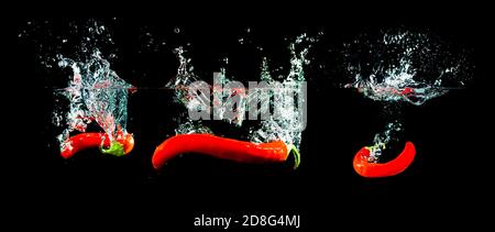 Fresh vegetables and water splashes in air on white background Stock ...