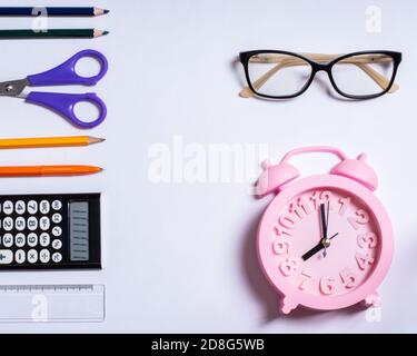 Set of stationery and alarm clock on red background Stock Photo - Alamy