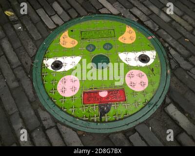 View of the manhole covers with cartoon paintings at Chengxi Street ...
