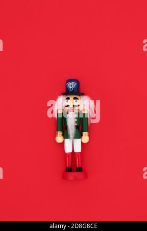 A nutcracker toy on top of the Christmas tree with colorful balls Stock ...