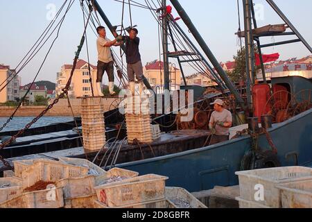 Citizens flock to the fish market located on the port, where fishermen ...