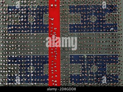 An aerial view of students arraying on the playground, attending a ...