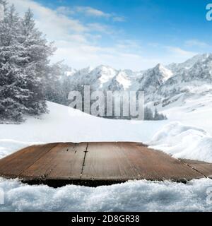 A wooden table top with a snowy white and blue Christmas scene with ...