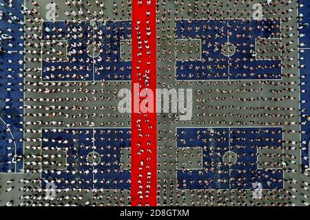 An aerial view of students arraying on the playground, attending a ...