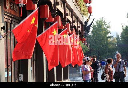 A line of Chinese national flags fly on the street prior to the ...