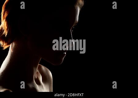 sad female profile silhouette on stars sky, monochrome image with ...