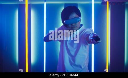 Gamer plays the game using virtual reality headset and gamepad in ...