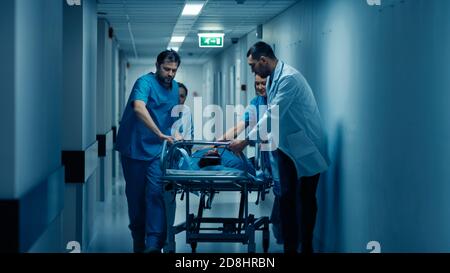 Doctors and nurses run and push stretcher with seriously injured ...
