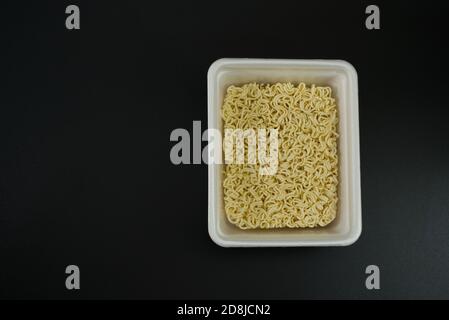 Dry instant noodles in rectangle plastic plate, top view Stock Photo ...