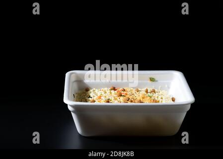 Dry instant noodles in rectangle plastic plate, top view Stock Photo ...