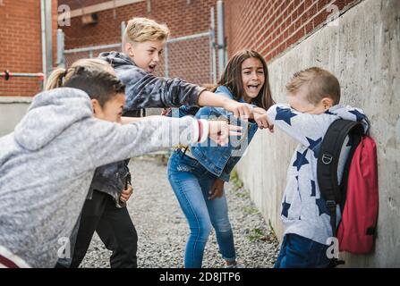 sad intimidation moment Elementary Age Bullying in Schoolyard Stock ...