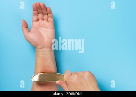 man scraping his arm by a copper scratcher which is a traditional ...