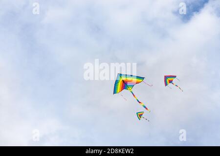 Coloful kites flying against blue sky with copy space Stock Photo - Alamy
