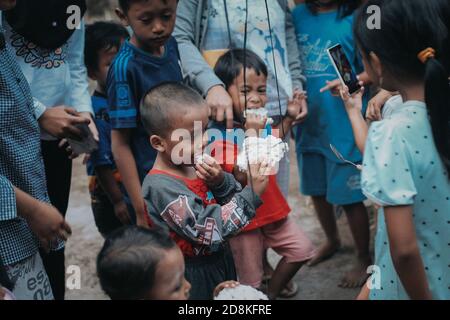 Purbalingga, Indonesia - August 13, 2018 : Kids eating cracker to ...