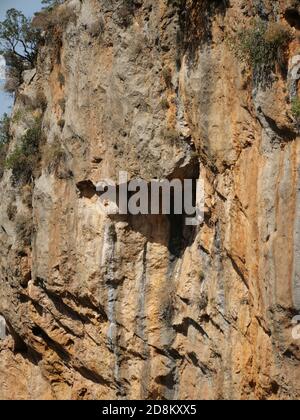 Vertical shot of the huge cliffs captured in Crete, Greece during the ...