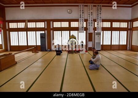 Doors at Shinto shrine in Tokyo, Japan. Name plate of the shrine above ...