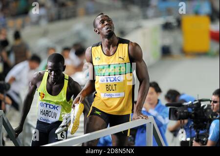 Former Jamaican sprinter Usain Bolt, right, arrives for a photo call ...