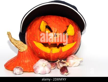 A scary Halloween pumpkin with garlic on white background Stock Photo ...
