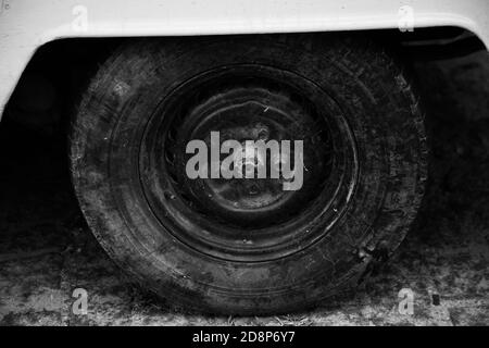 A grayscale shot of a dirty and old tire and broken concrete Stock ...