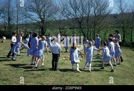 primary school children doing a traditional english country dance in ...