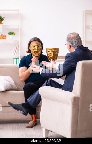 Man wearing masks during psychotherapy session Stock Photo - Alamy