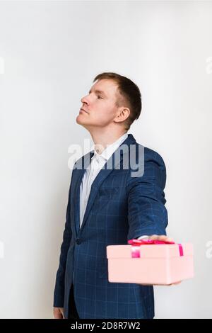 Surprised man with short dark hair holding cell phone and clenching ...