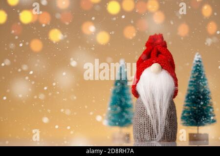 Cute christmas gnome is sitting and waiting for his presents for ...