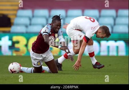 Aston Villa's Bertrand Traore (left) and Everton's Ben Godfrey battle ...