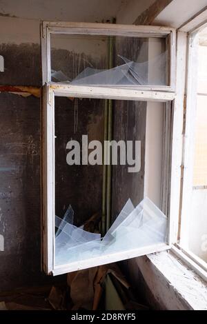 A wooden window frame with broken glass Stock Photo - Alamy