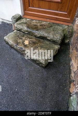 2 very old shallow stone door steps leading to a house front door Stock ...