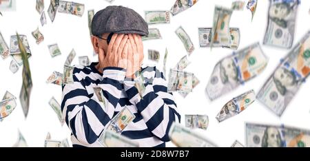 Senior handsome man wearing burglar mask and t-shirt gesturing with ...