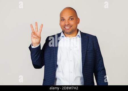 young man showing three fingers over sky Stock Photo - Alamy