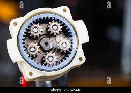 Steel cogwheels in part of planetary gearset inside screw gun on gold ...