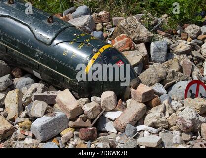 Military warhead / ordnance / munitions amongst rubble. Comment on ...