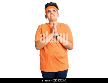 Cute little boy begging for his request, holding hands together, orange ...