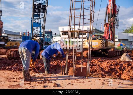Construction worker repairing road, pouring boiling bitumen by hand ...