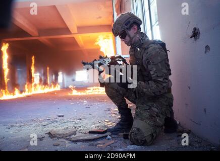 soldier in action near window changing magazine and take cover Stock ...