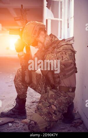 soldier in action near window changing magazine and take cover Stock ...