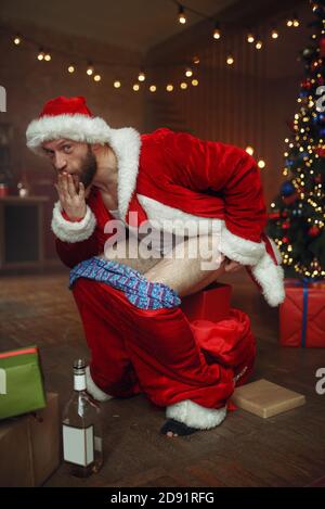 Bad Santa claus pooping in gift box, humor Stock Photo - Alamy