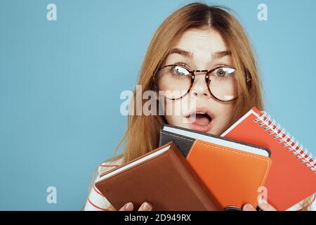 energetic female student with notepads and glasses model blue ...