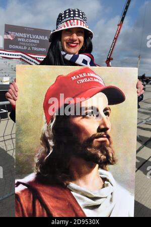 A woman carries a portrait of Jesus in a MAGA (Make America Great Again ...