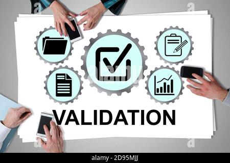 Validation concept placed on a desk with hands using smartphones Stock ...