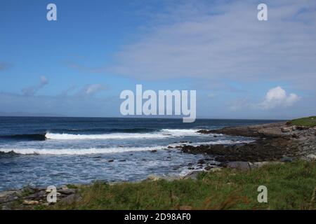 A mesmerizing shot of a rocky seashore under a cloudy sky Stock Photo ...